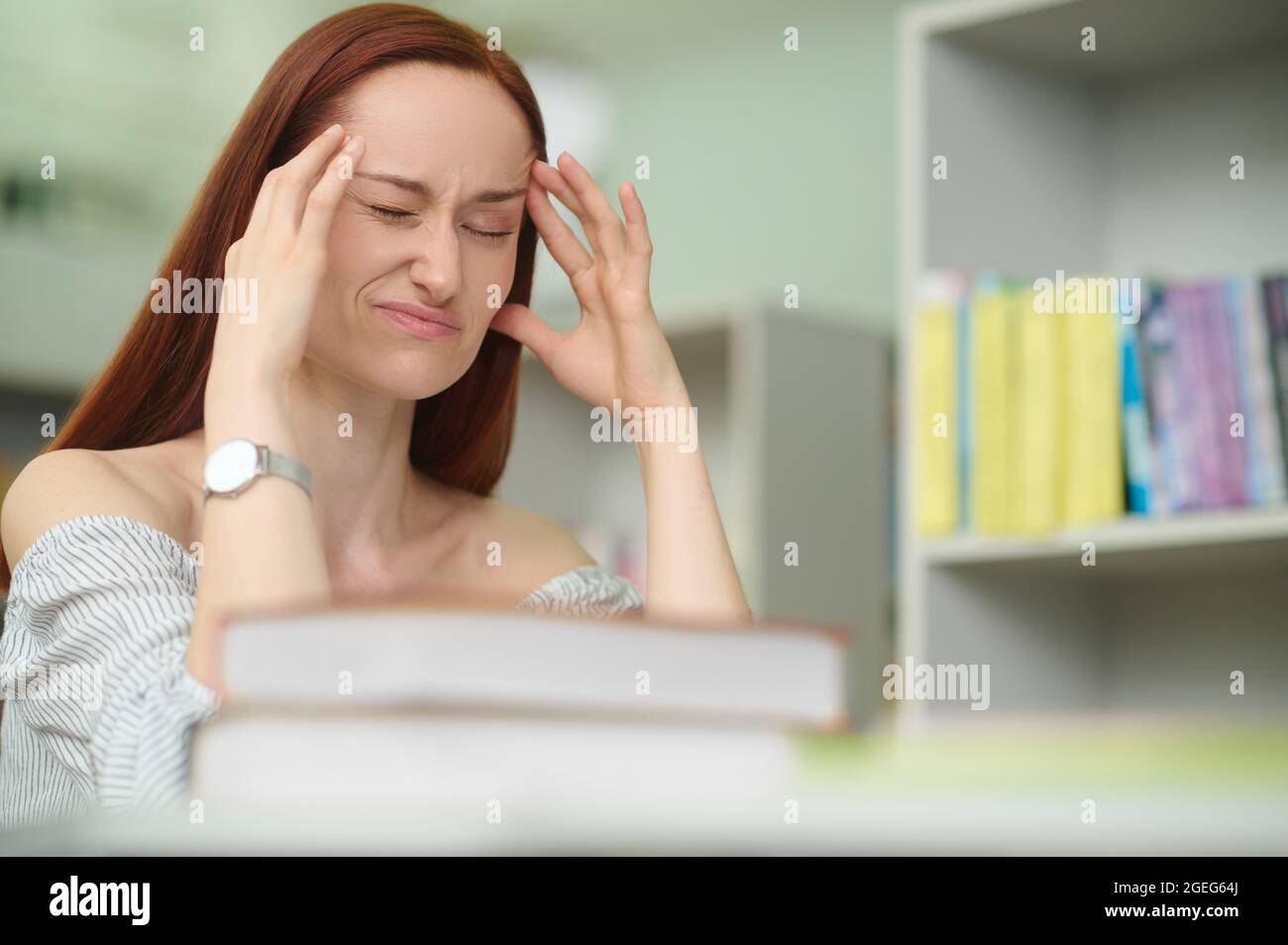 Overworked female researcher suffering from a splitting headache Stock ...