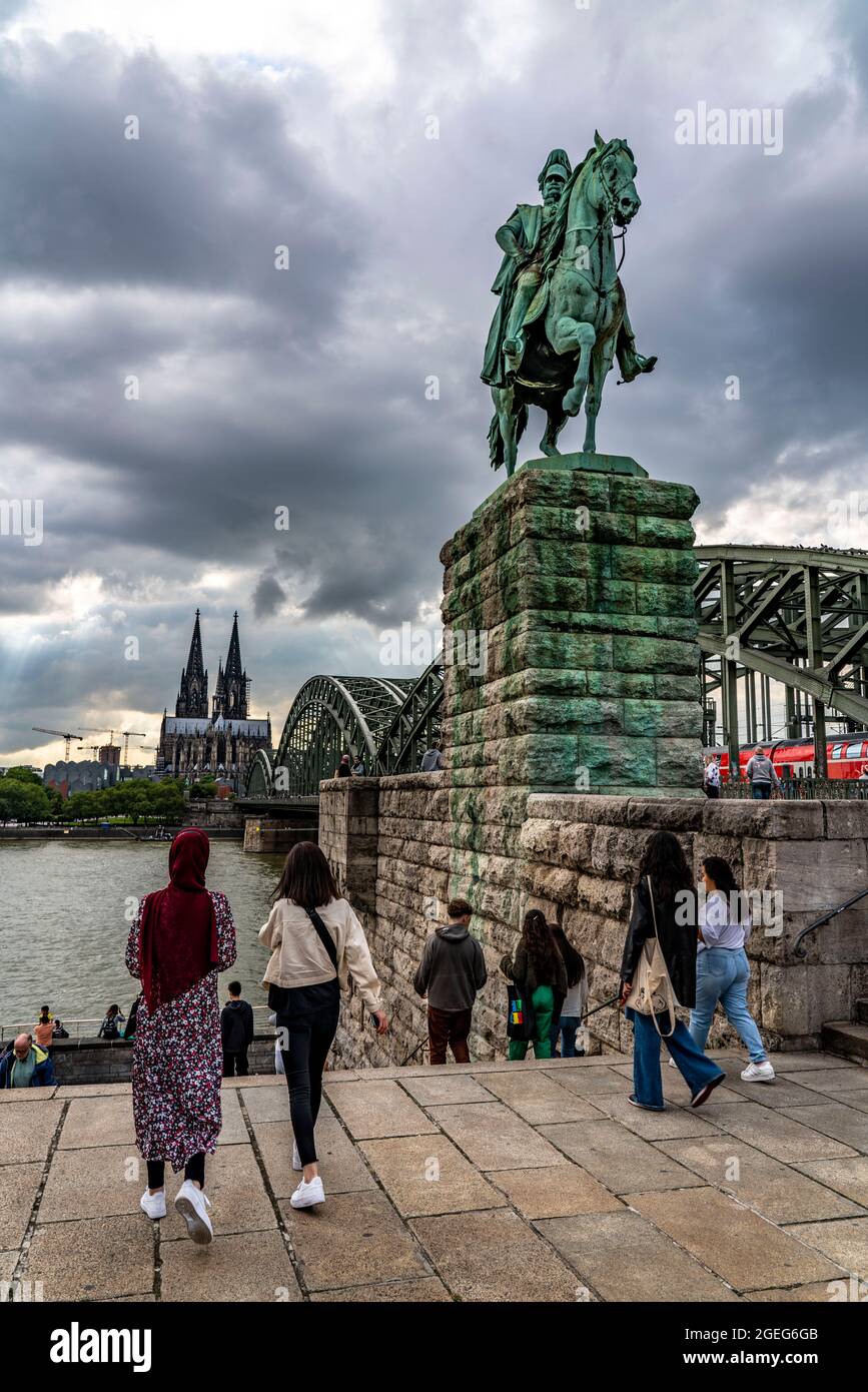 Cologne Cathedral, people on the Hohenzollern Bridge, equestrian statue ...