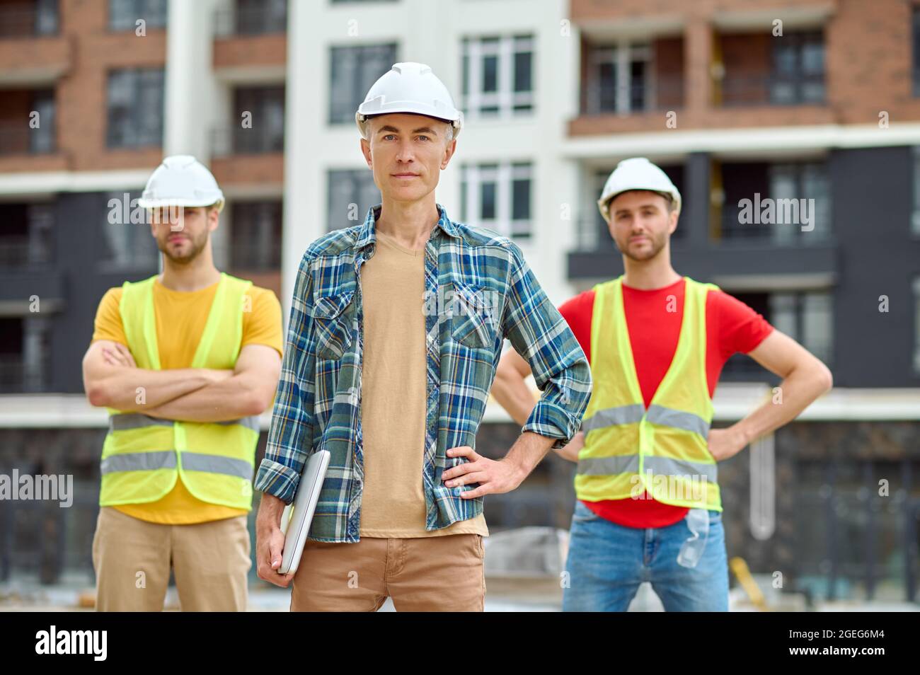 Men in helmets standing construction hi-res stock photography and ...