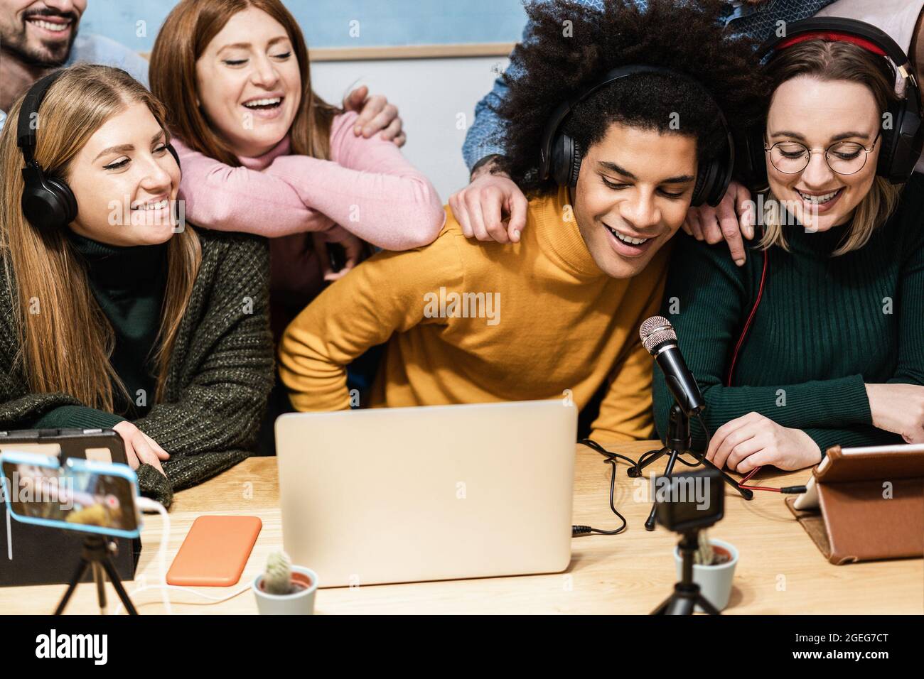 Happy diverse friends having fun streaming online using computer laptop ...