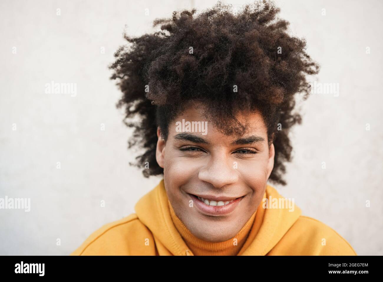 Young african man smiling on camera outdoor in the city - Focus on face ...