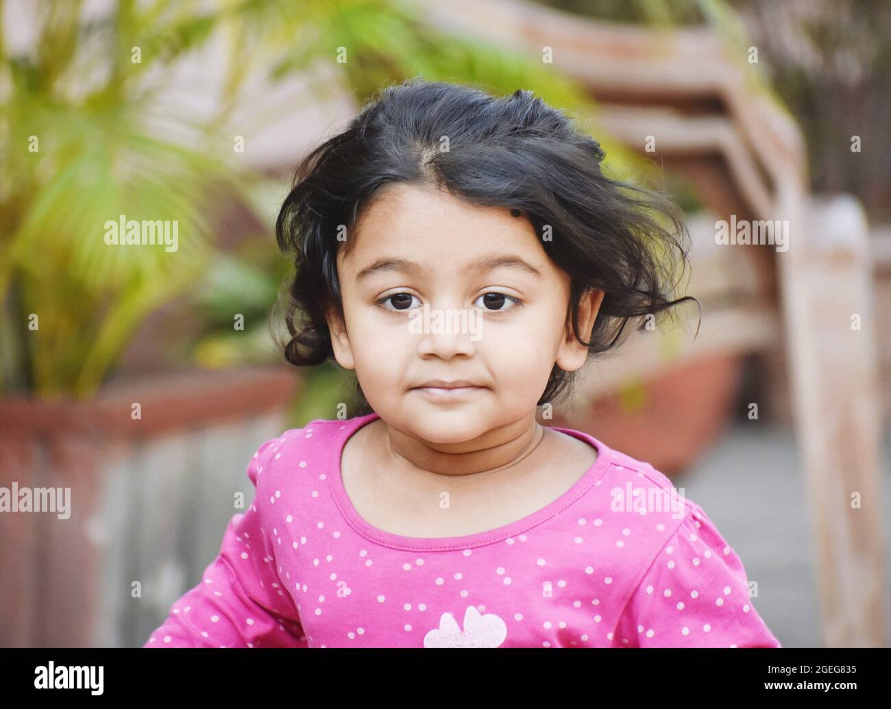 Closeup shot of a cute South Asian baby girl with beautiful black hair ...