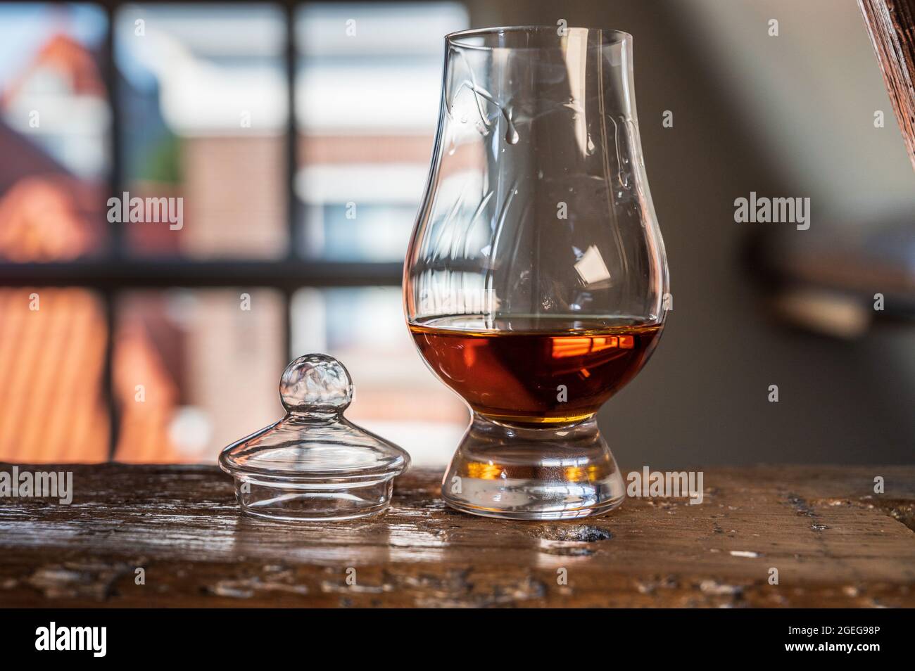 Dram of single malt scotch whisky served in tasting glass with view on ...