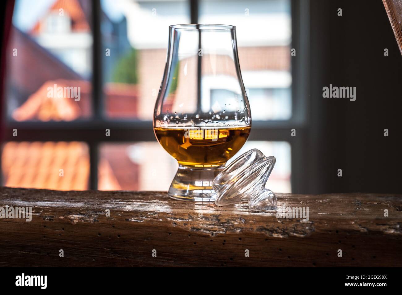 Dram of single malt scotch whisky served in tasting glass with view on ...