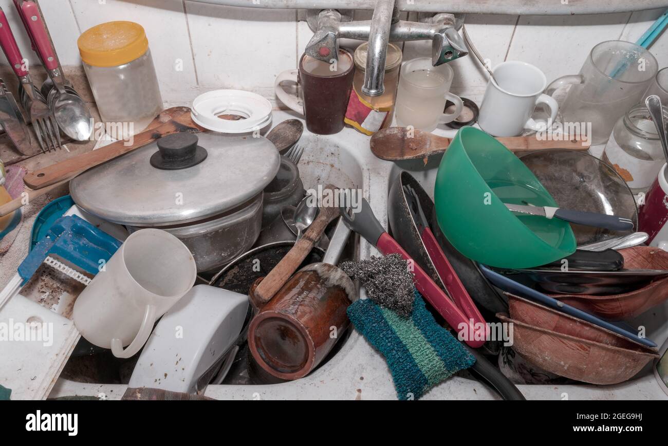Stack dirty dishes in sink hi-res stock photography and images - Alamy