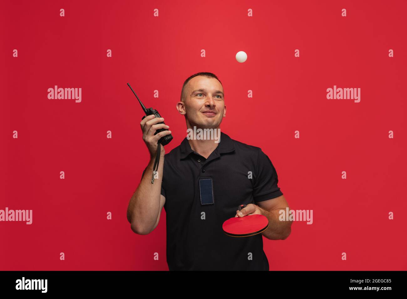 One young caucasian man with ping pong racket and walkie-talkie playing ...