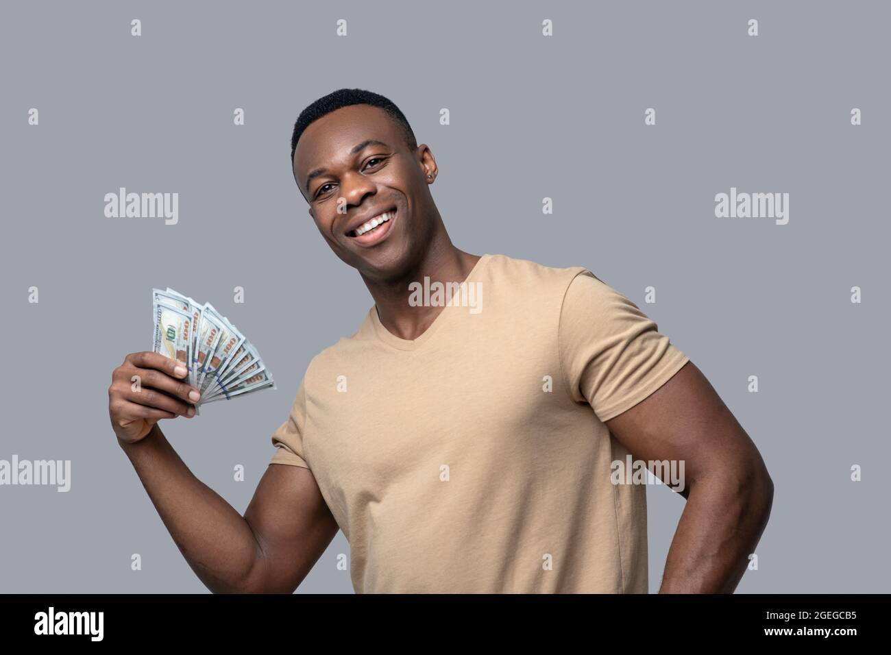African american young man holding money in his hands Stock Photo - Alamy