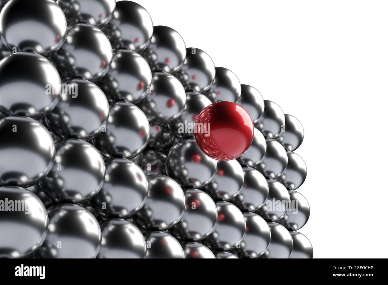 Red sphere in front of wall of silver balls on white background ...