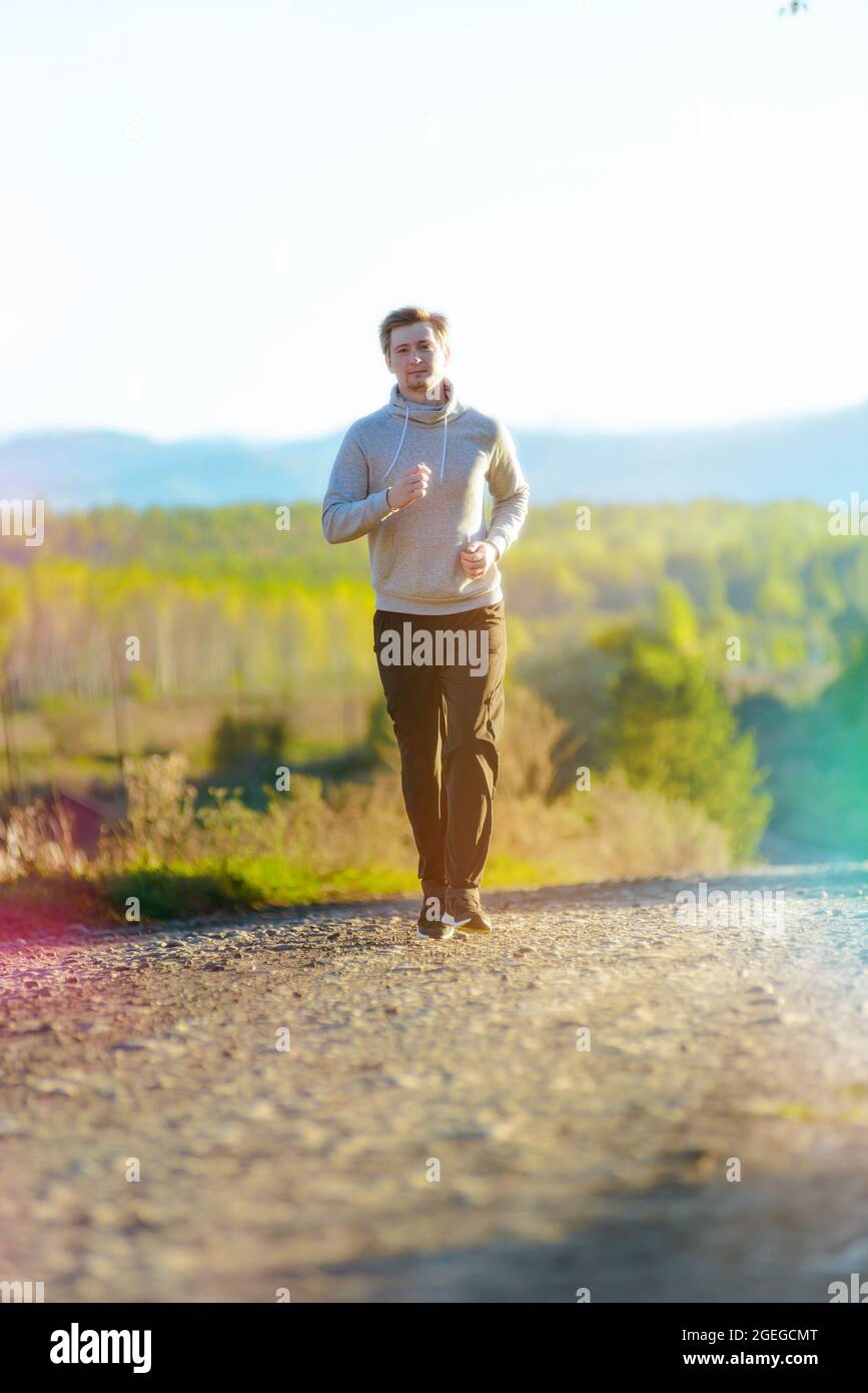 Running man jogging in rural nature at beautiful summer day. Sport ...