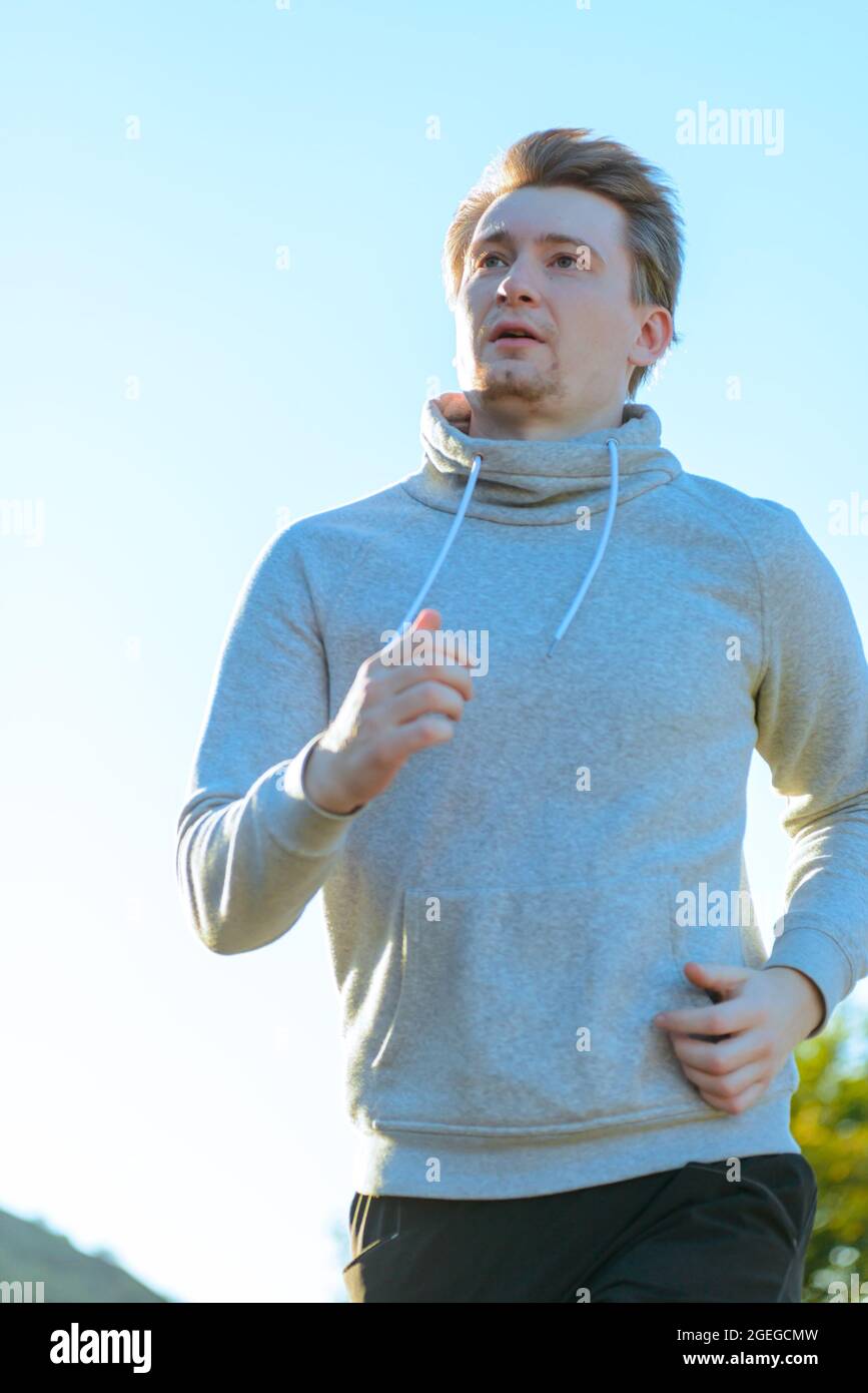 Running man jogging in rural nature at beautiful summer day. Sport ...