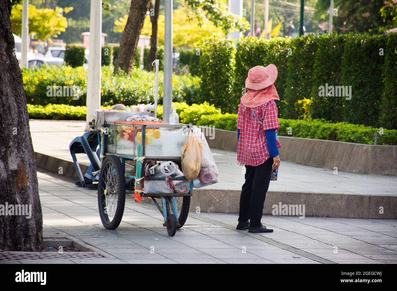 Thai old woman people push tricycle cart hawker on road sale variety ...