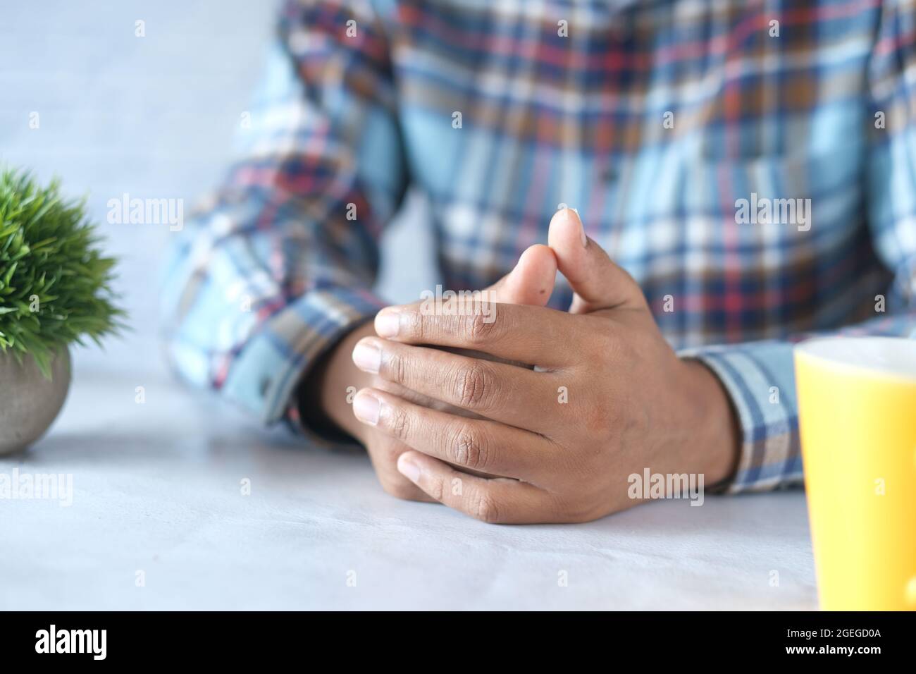 a nervous young man hand Stock Photo - Alamy