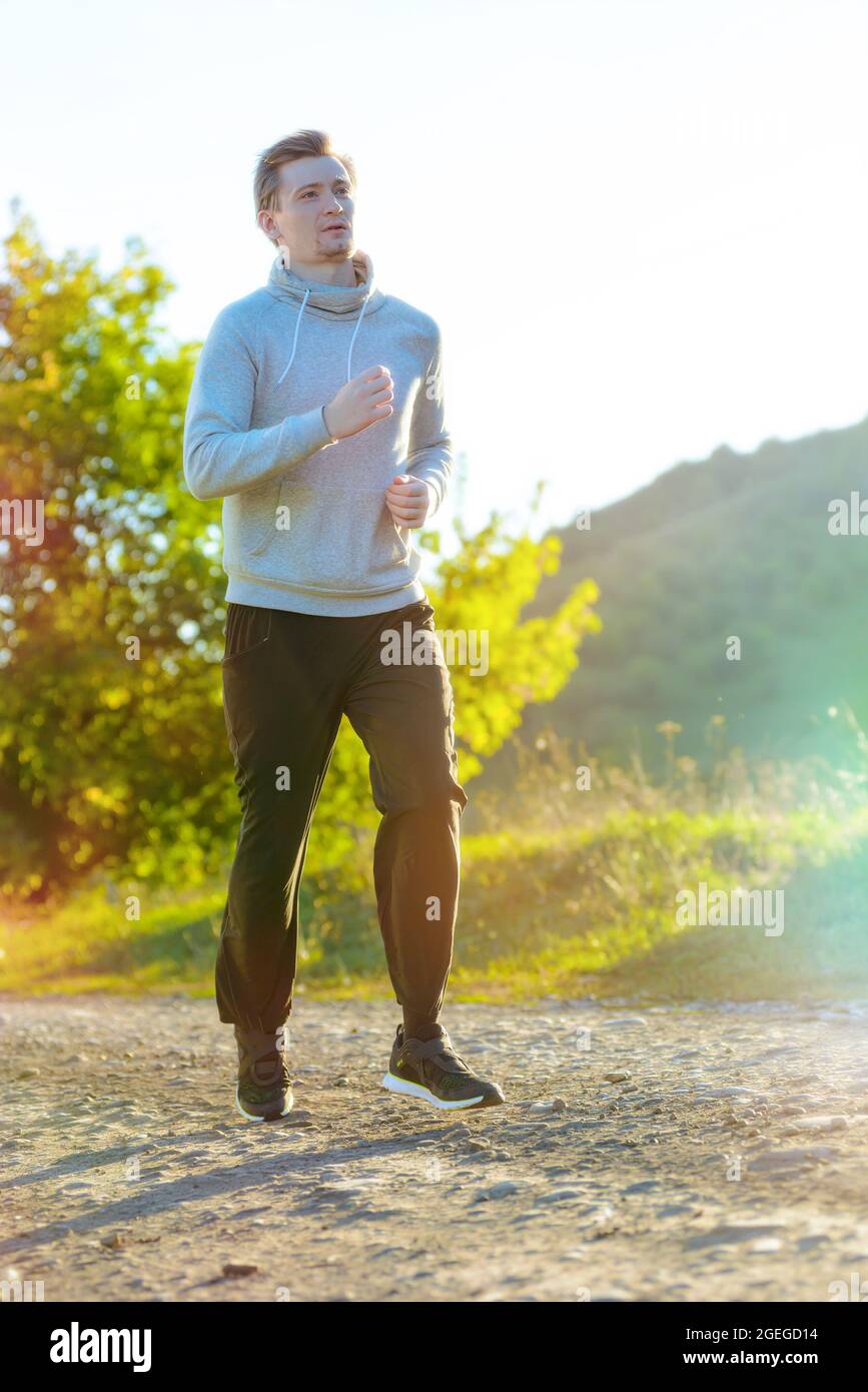 Running man jogging in rural nature at beautiful summer day. Sport ...