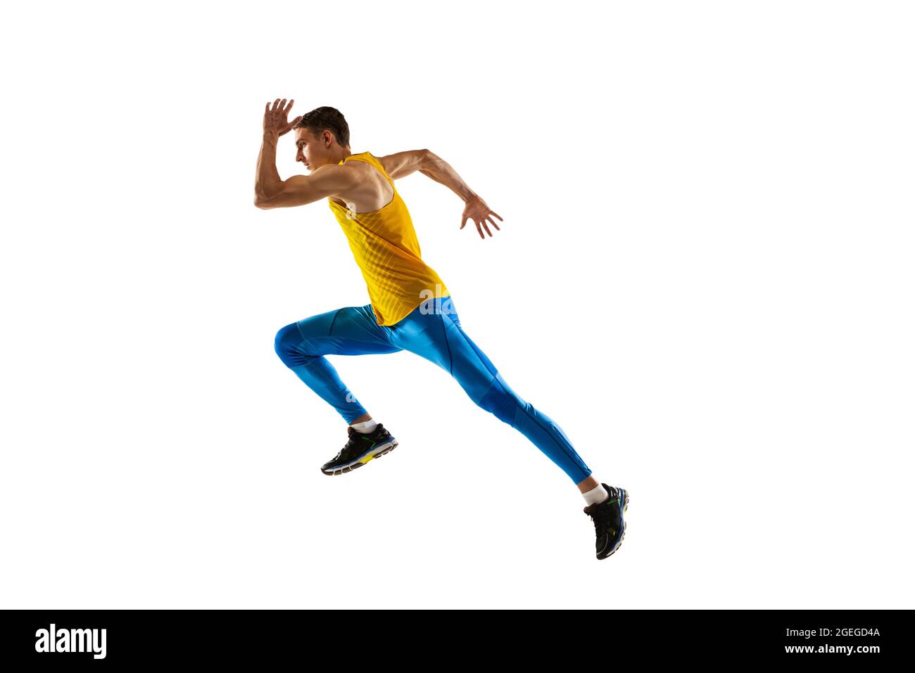 Profile view of Caucasian professional male athlete, runner training ...