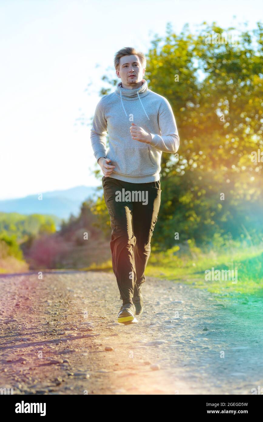 Running man jogging in rural nature at beautiful summer day. Sport ...