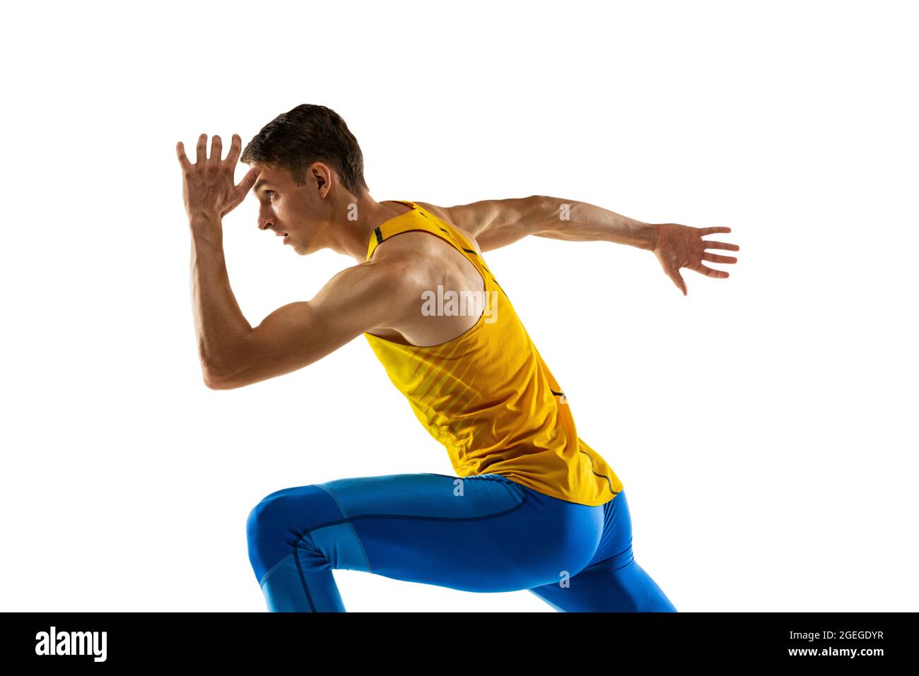 Profile view of Caucasian professional male athlete, runner training ...