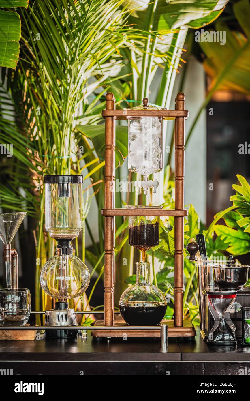cold drip coffee tower with soft-focus and over light in the background ...