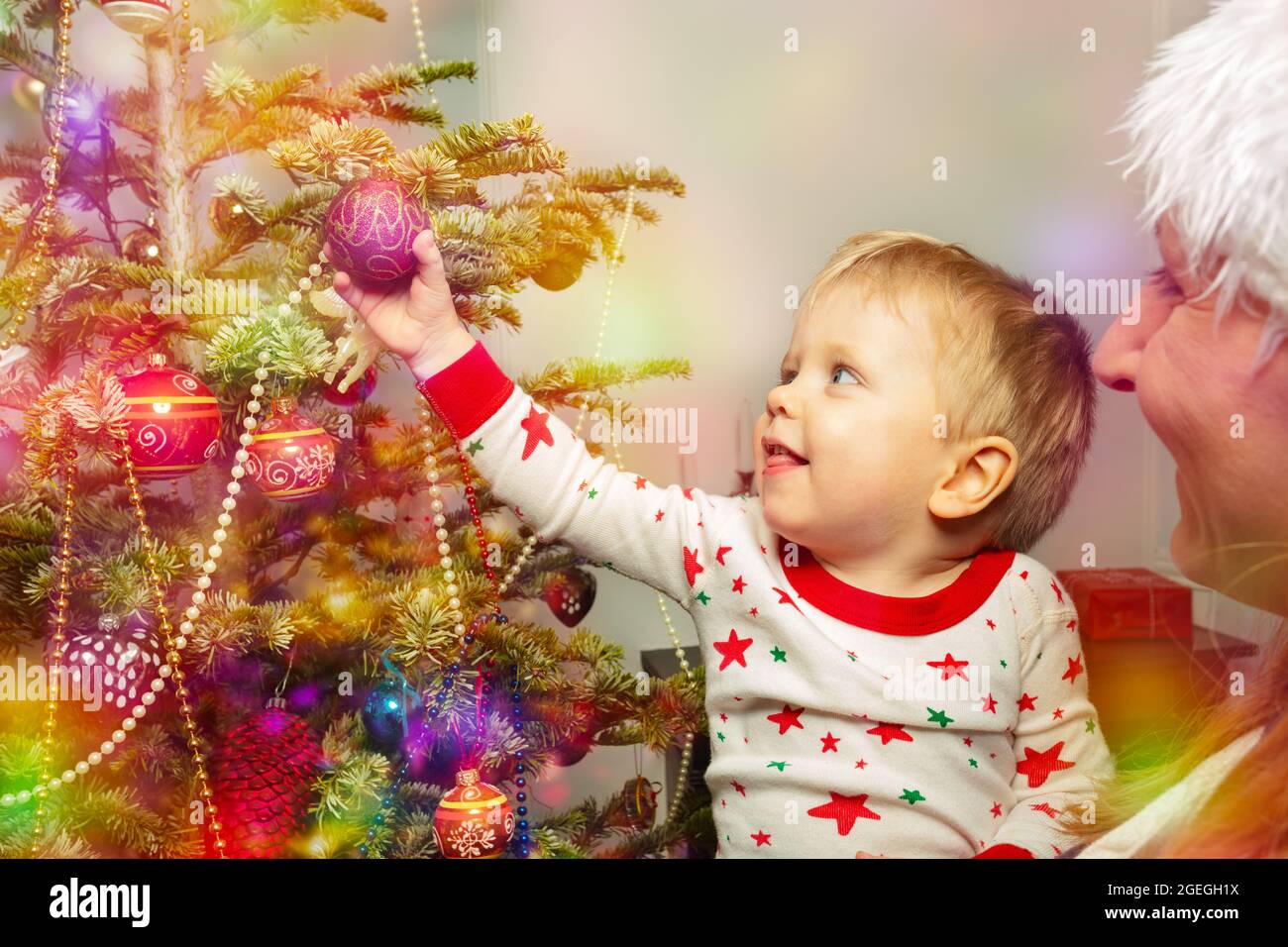 Baby boy holding red ball hi-res stock photography and images - Alamy