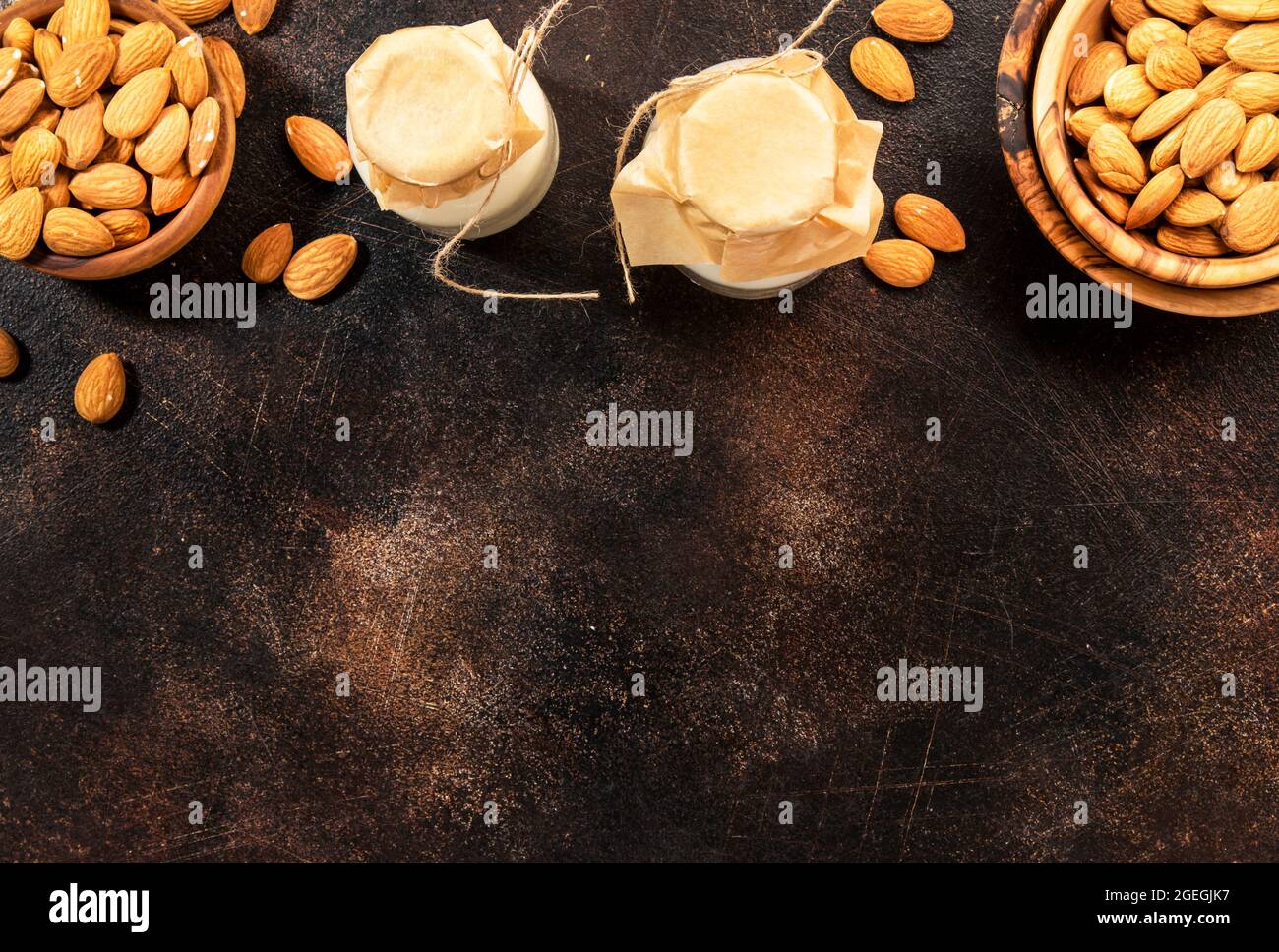 Plant based almod milk in bottles on brown background. Copy space. Top ...