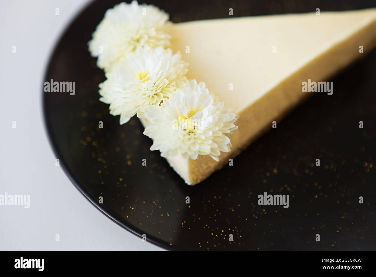 creamy cheesecake decorated with white flowers, close-up Stock Photo ...