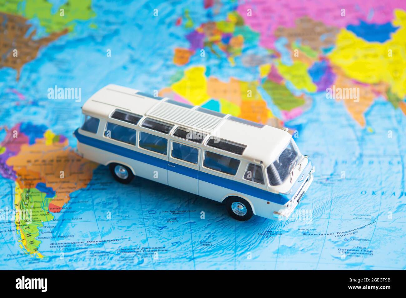 Bus on the atlas. World map, close-up Stock Photo - Alamy