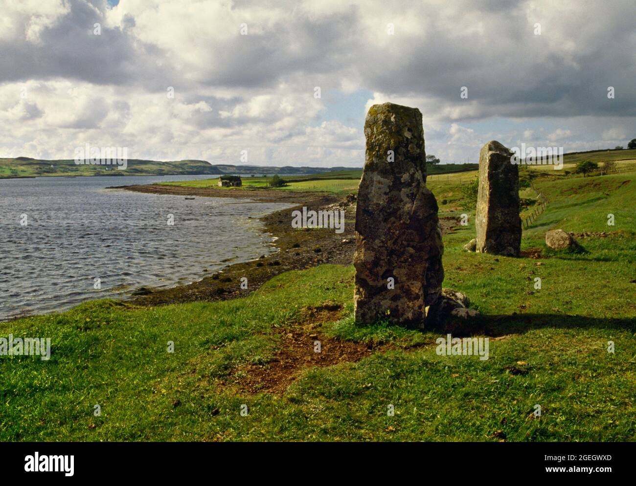 View NW of two standing stones on a narrow terrace above the N shore of ...