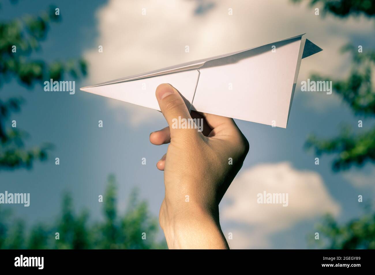 Paper plane in hand against the background of the sky. Origami Stock ...