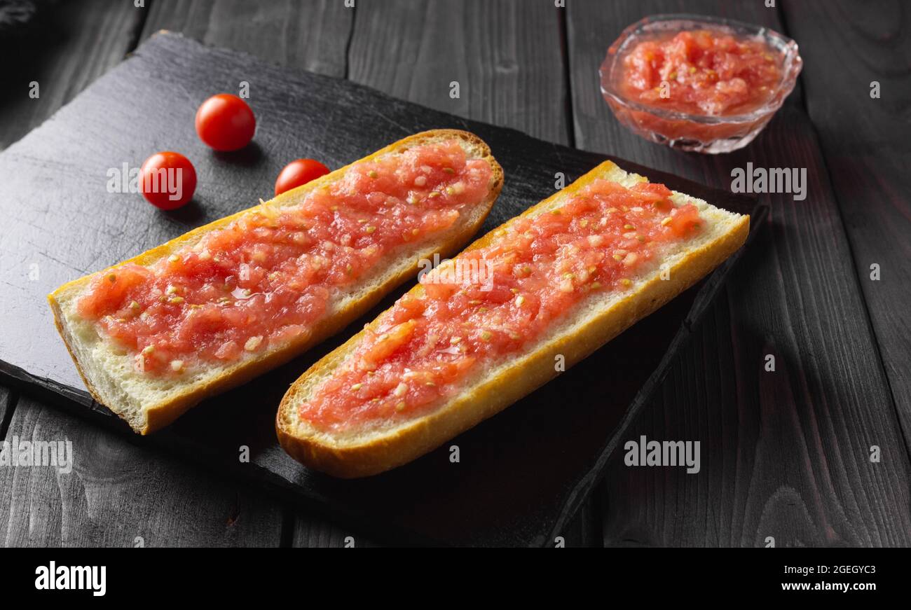 Toast with tomato, traditional Spanish breakfast. Olive oil, black ...
