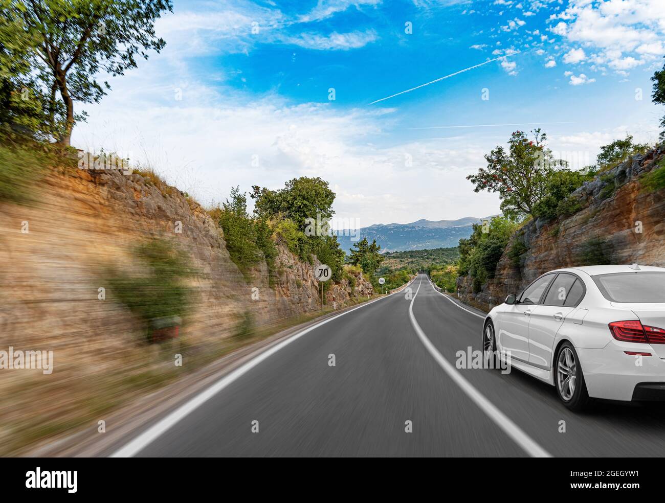 Car is driving along the road. White car on a suburban highway Stock ...