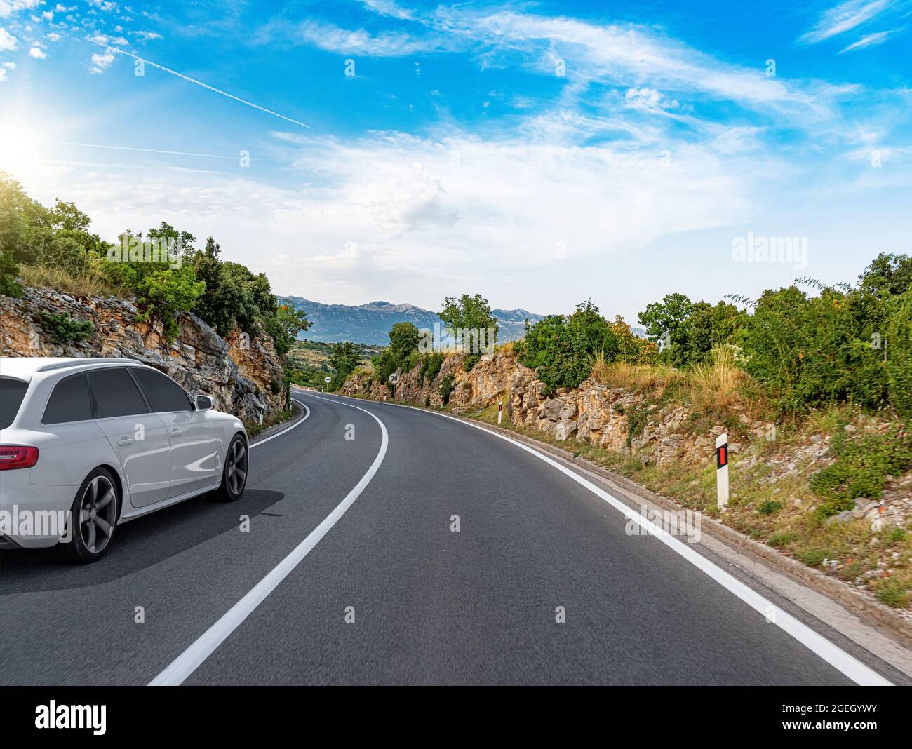 White sedan driving along hi-res stock photography and images - Alamy