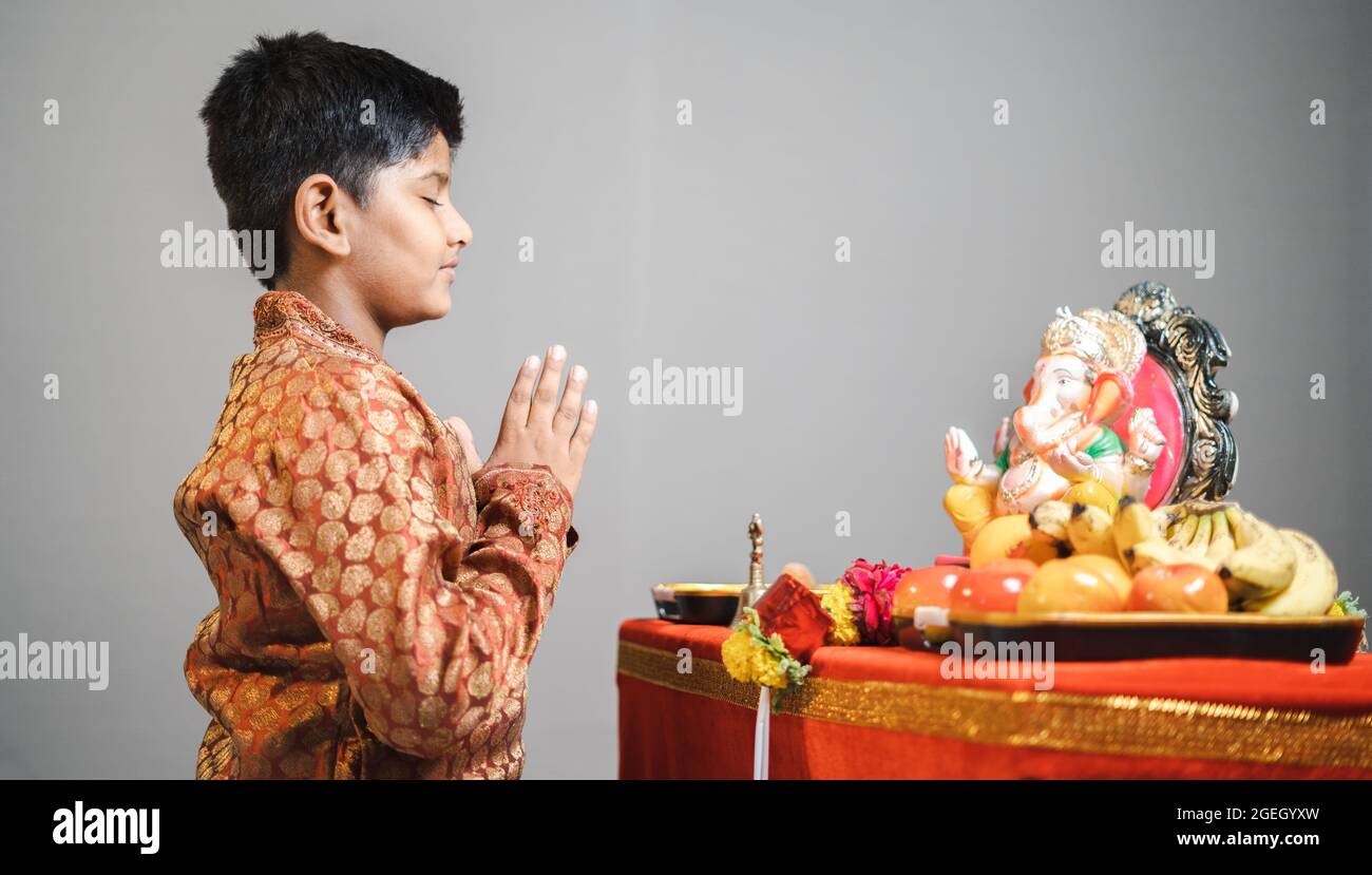Studio shot of kid during ganesha festival with traditional dress ...