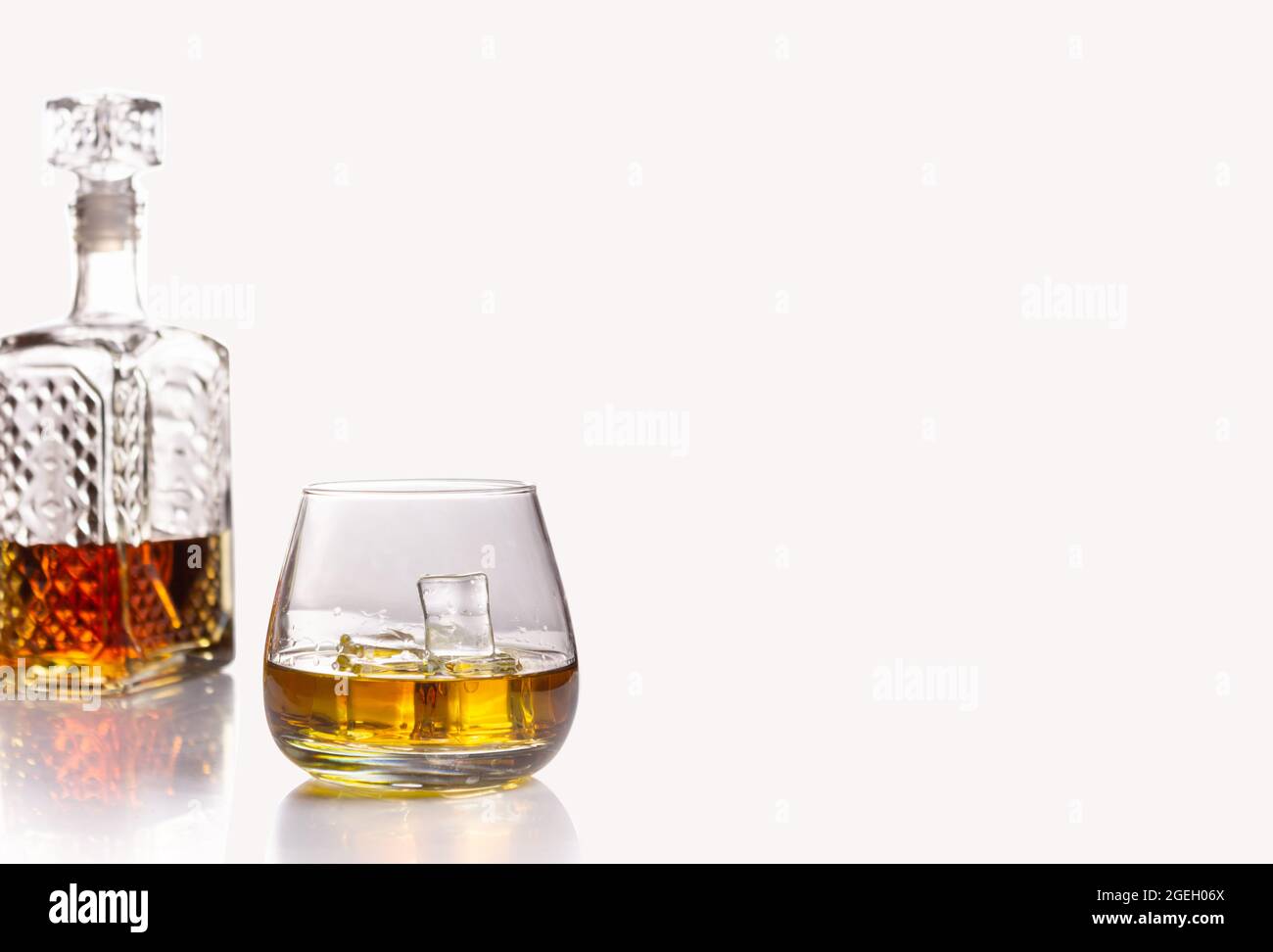 A glass decanter half filled with cognac or other alcoholic beverage ...