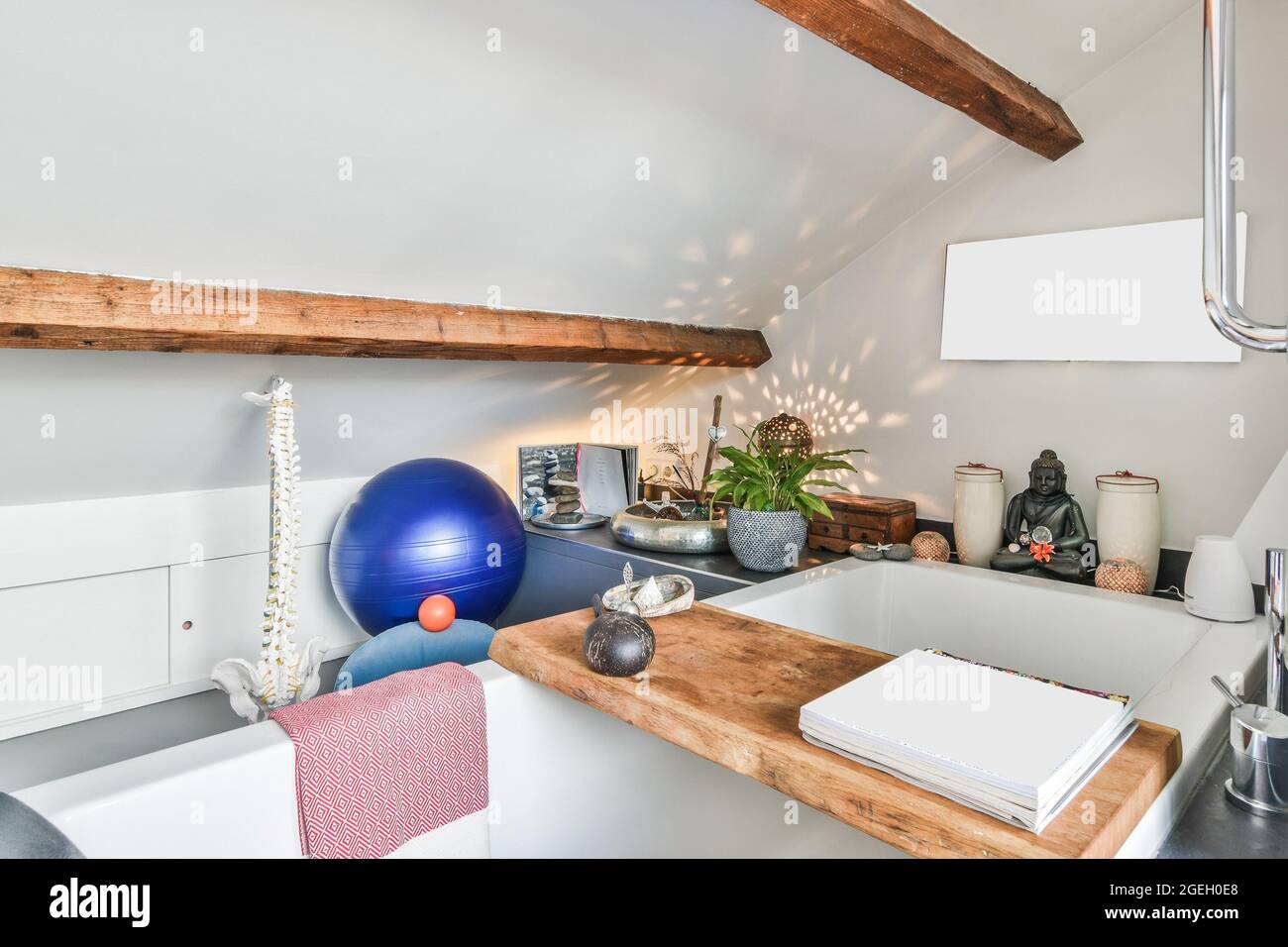 Calming objects and candles by a bathtub in a modern bathroom Stock ...