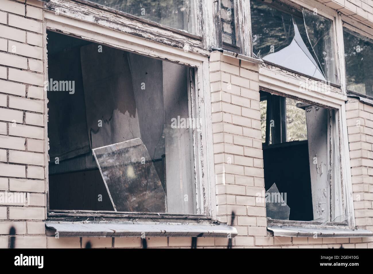 Broken glass in windows of old abandoned building with tiles Stock ...