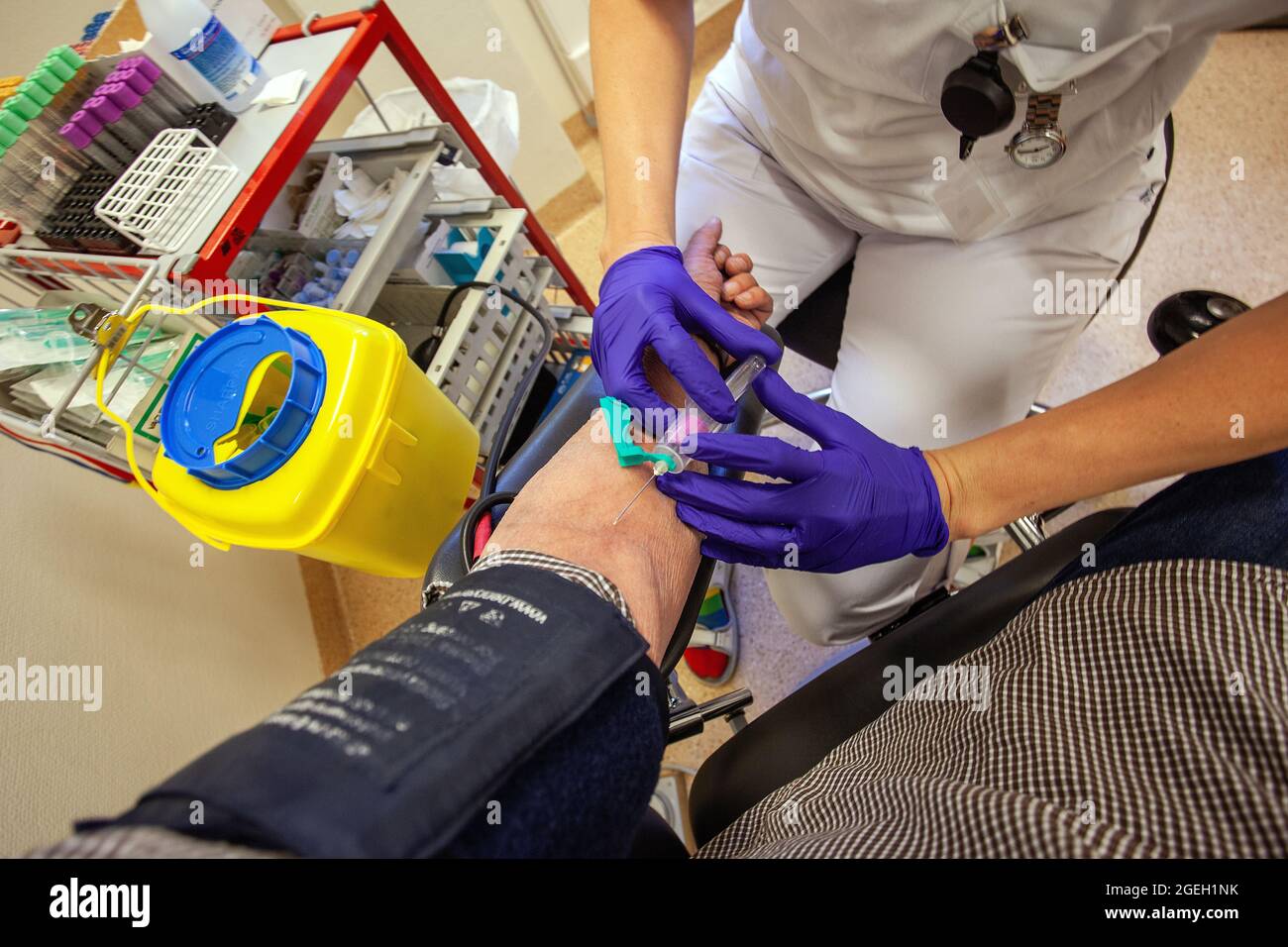 Blood test being performed on a middle aged man's arm by a Practice ...