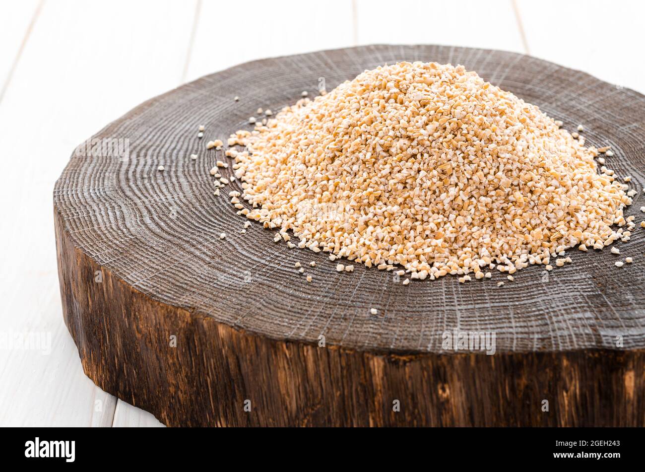 Raw dried broken barley cereal grain texture background macro closeup ...