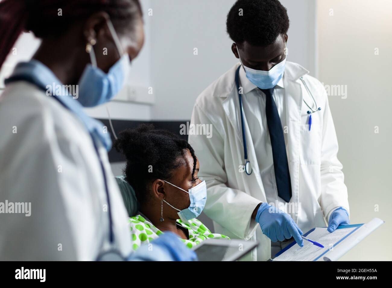 Medical team of african american doctors giving healthcare advice to ...