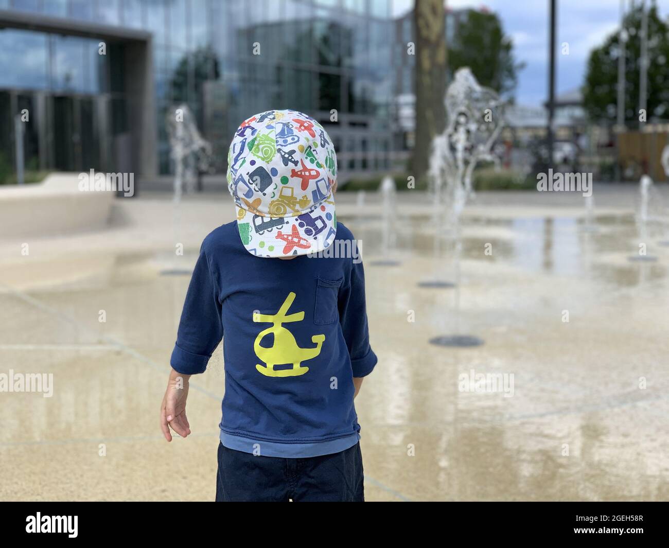 Shallow depth of field shot of the boy with a cap looking down on a ...