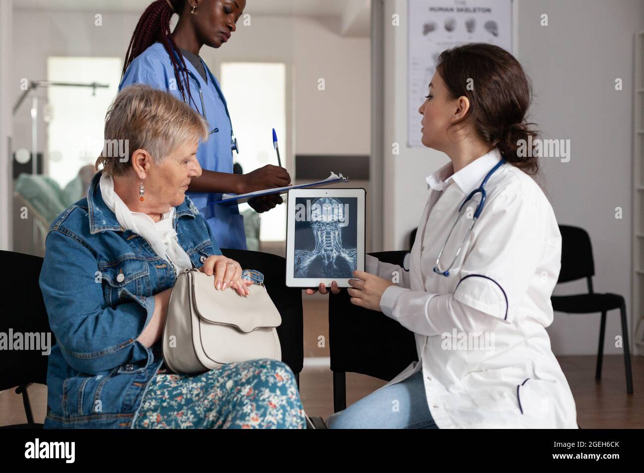 Physician doctor explaining medical radiography to elderly senior woman ...