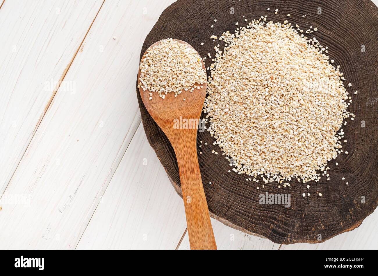Raw dried broken barley cereal grain texture background macro closeup ...