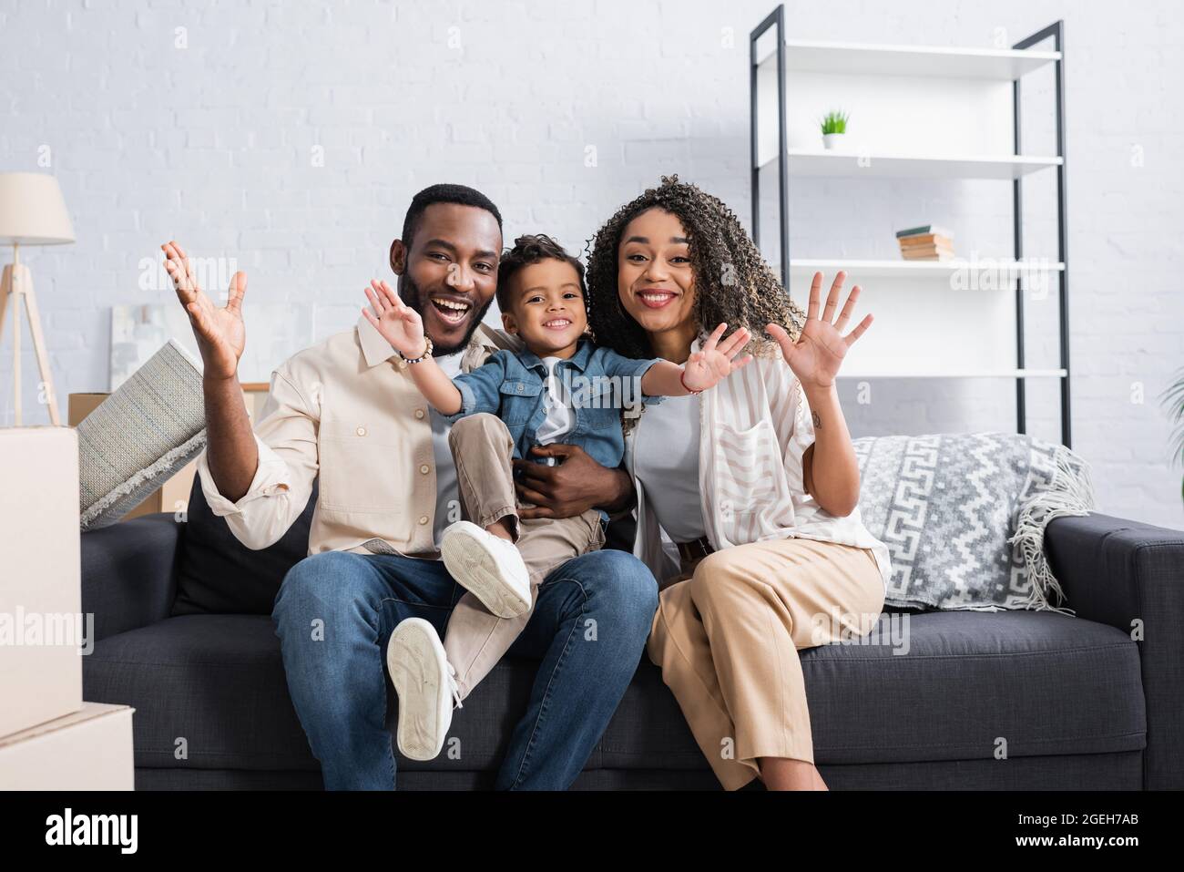 Happy family waving hands camera hi-res stock photography and images ...