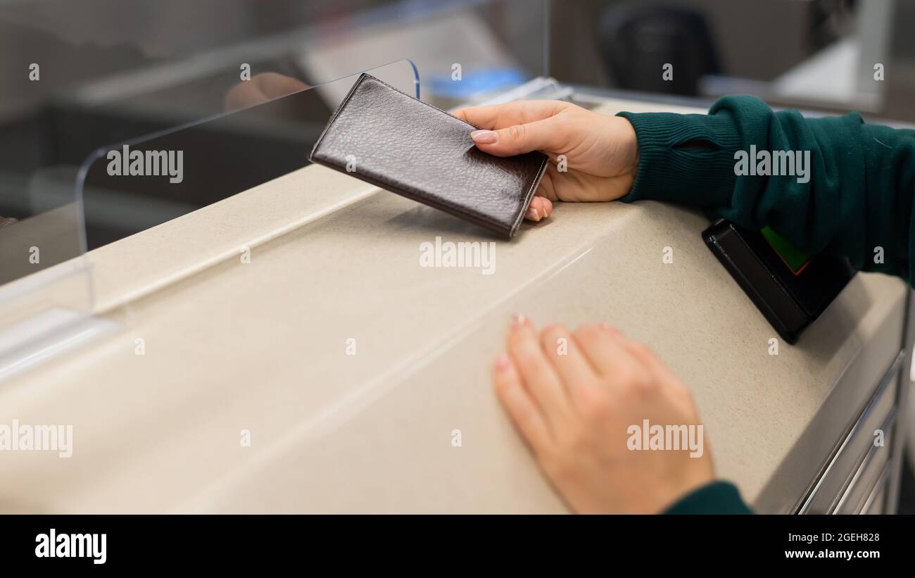 Faceless Woman At The Airport Holding Out Passport Assistant To The