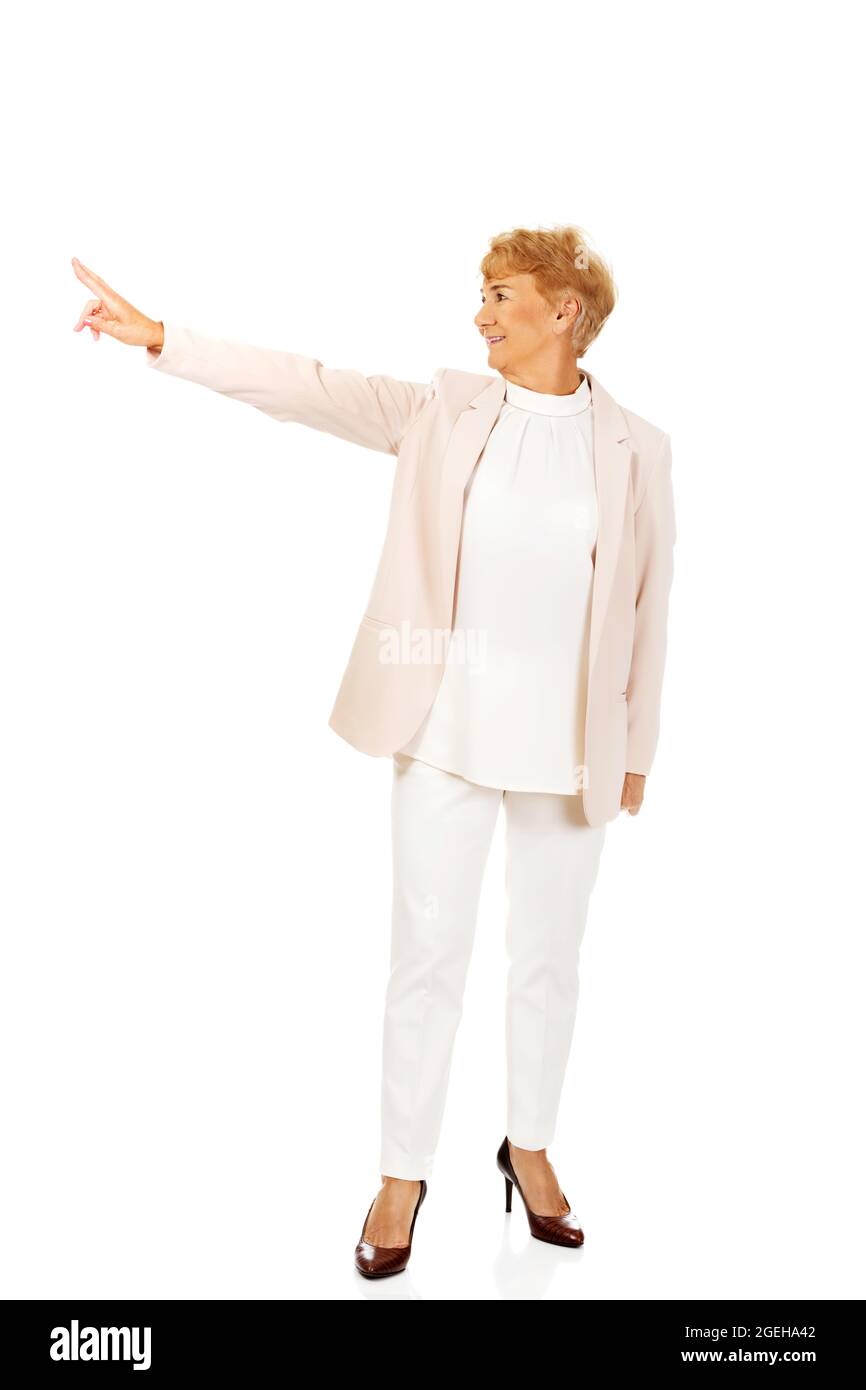 Woman pointing finger side wearing Cut Out Stock Images & Pictures - Alamy