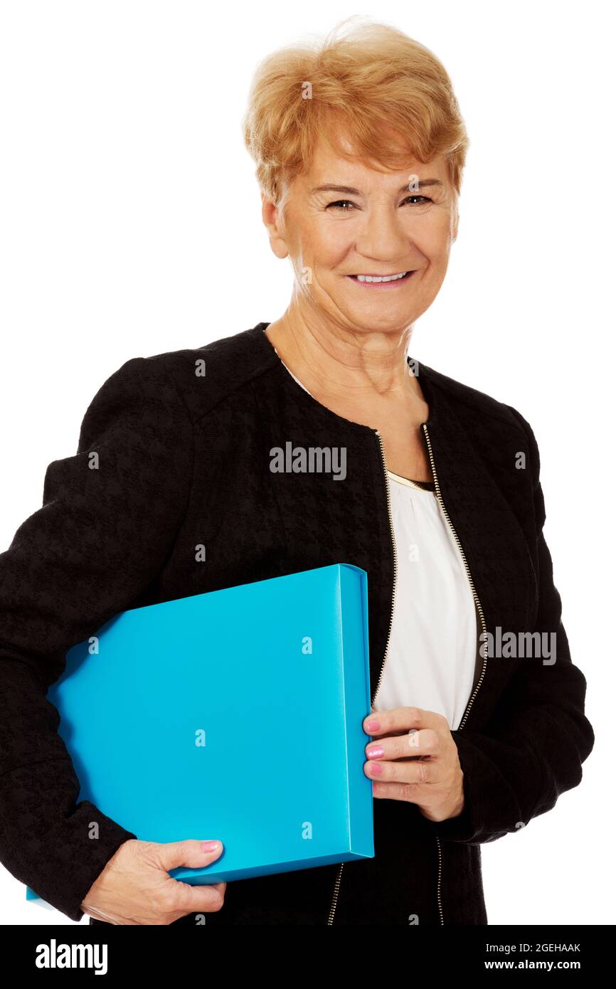 Senior elegant Caucasian businesswoman holding a file folder and ...