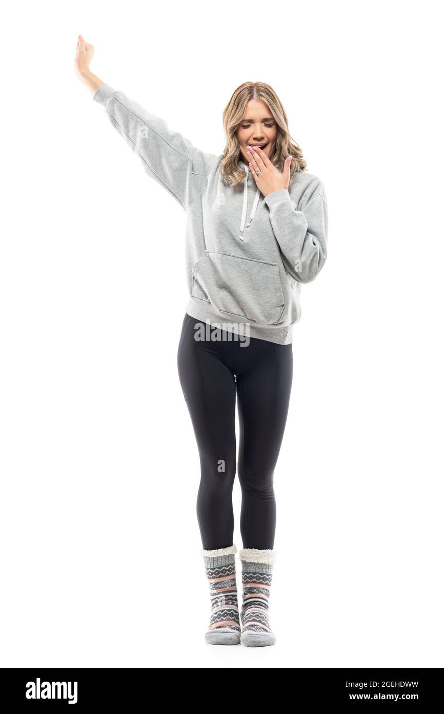 Cute lazy young pretty woman waking up stretching arms and yawning in ...