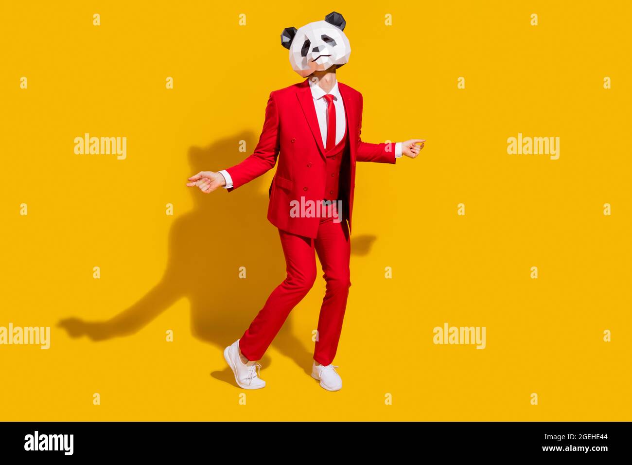 Photo of careless disco panda guy dance have fun wear mask red suit tie ...