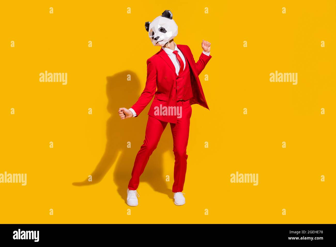 Photo of cheerful carefree panda guy dance wear mask red suit tie ...