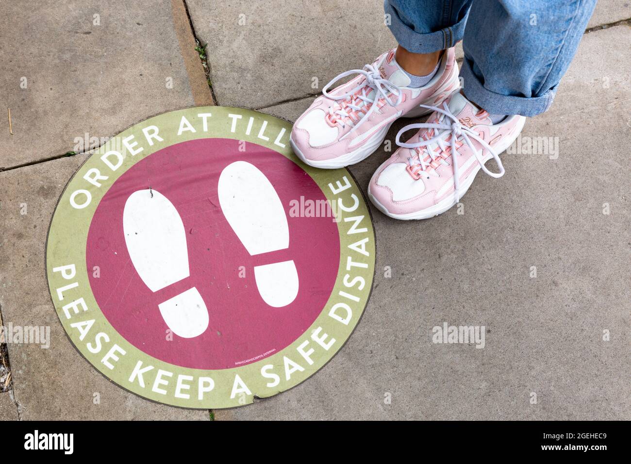 Sign on a UK pavement showing where to stand in a queue during the ...