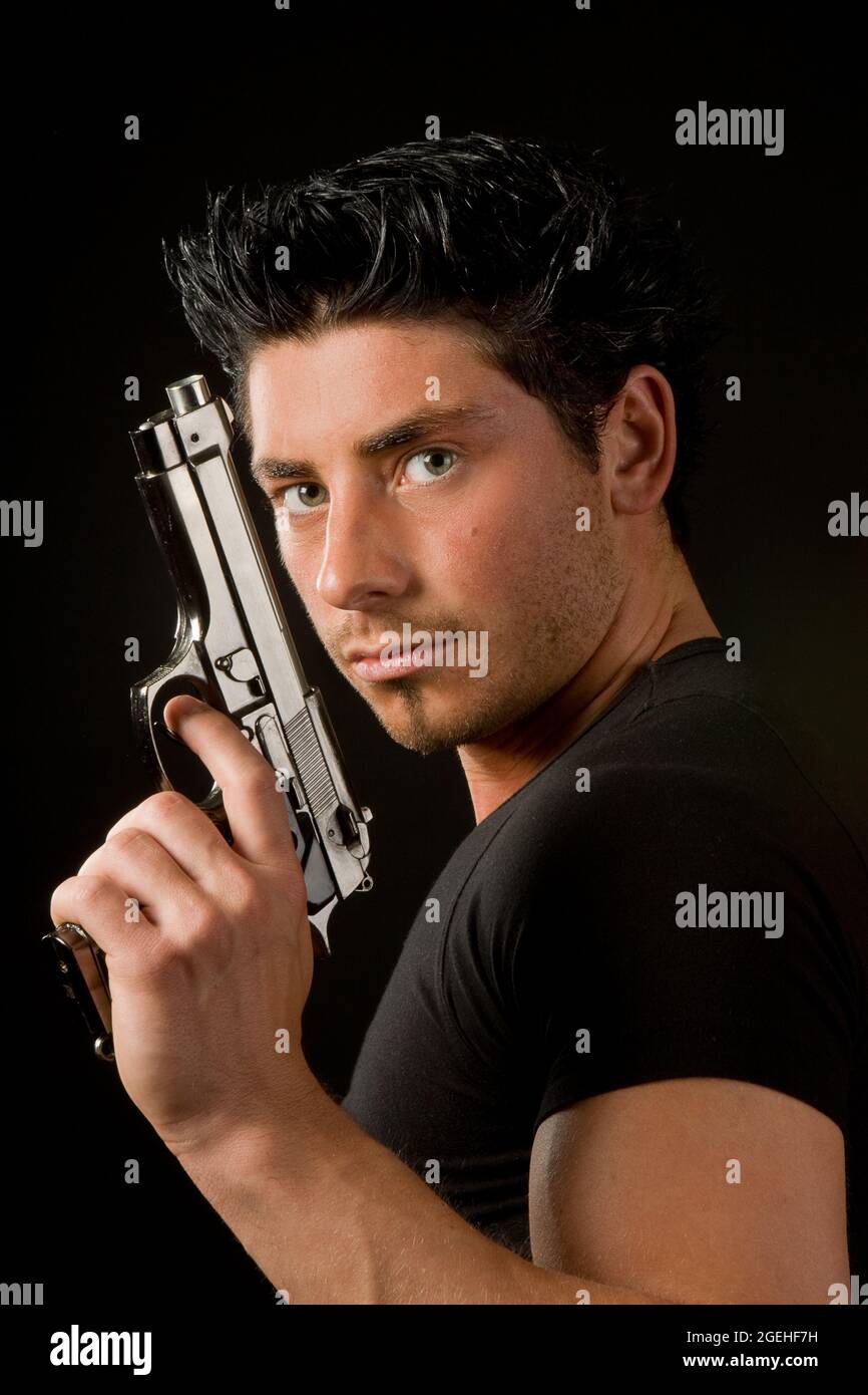 Thief criminal terrorist holding gun hi-res stock photography and ...