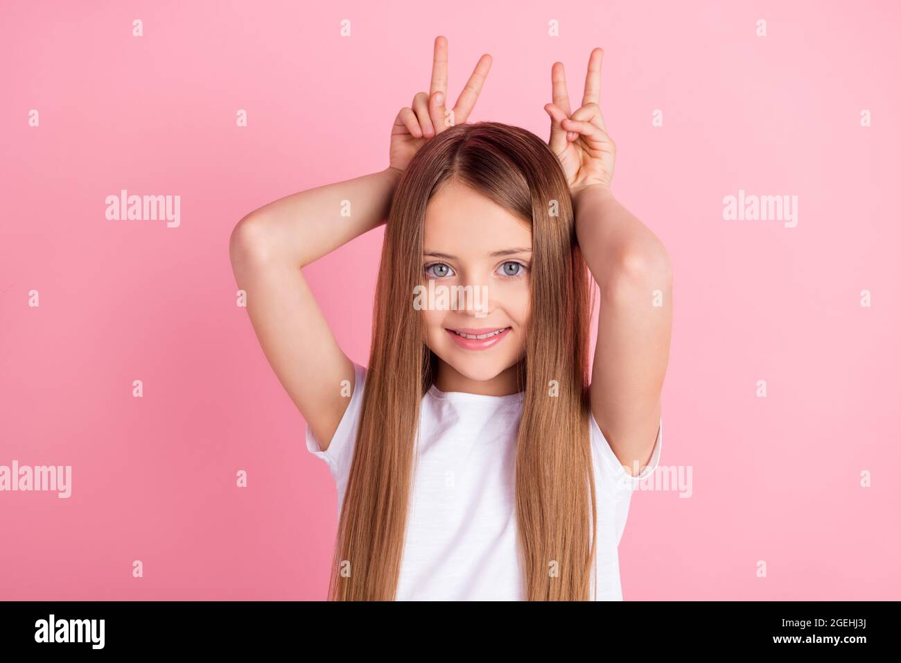 Photo of funky blond little girl show v-sign wear white t-shirt ...